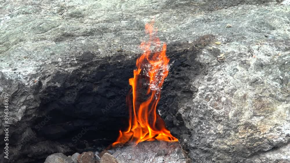 Flame of Methane Underground Emerges From Crack Between Rocks and Burns ...