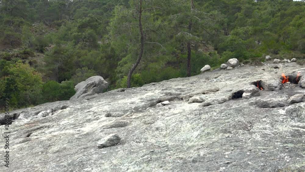 Flame of Methane Underground Emerges From Crack Between Rocks and Burns ...
