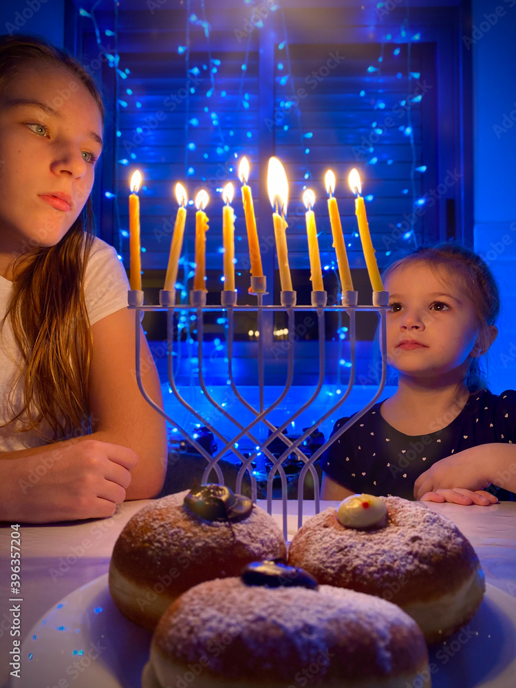 Children celebrate Hanukkah. Jewish festival of lights. Children light ...