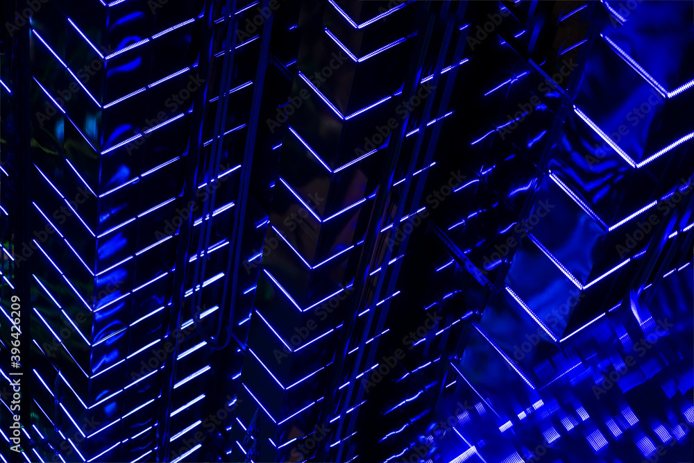 Abstract dark high-rise building at night, modern glass wall with ...