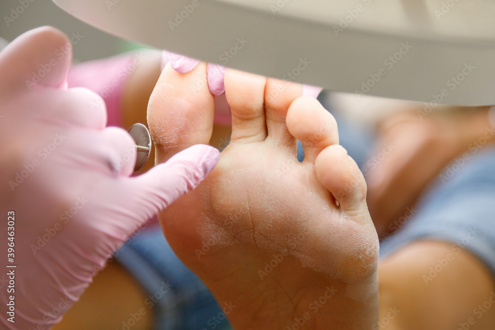 Women's feet and pedicure master. Professional hardware pedicure in a ...