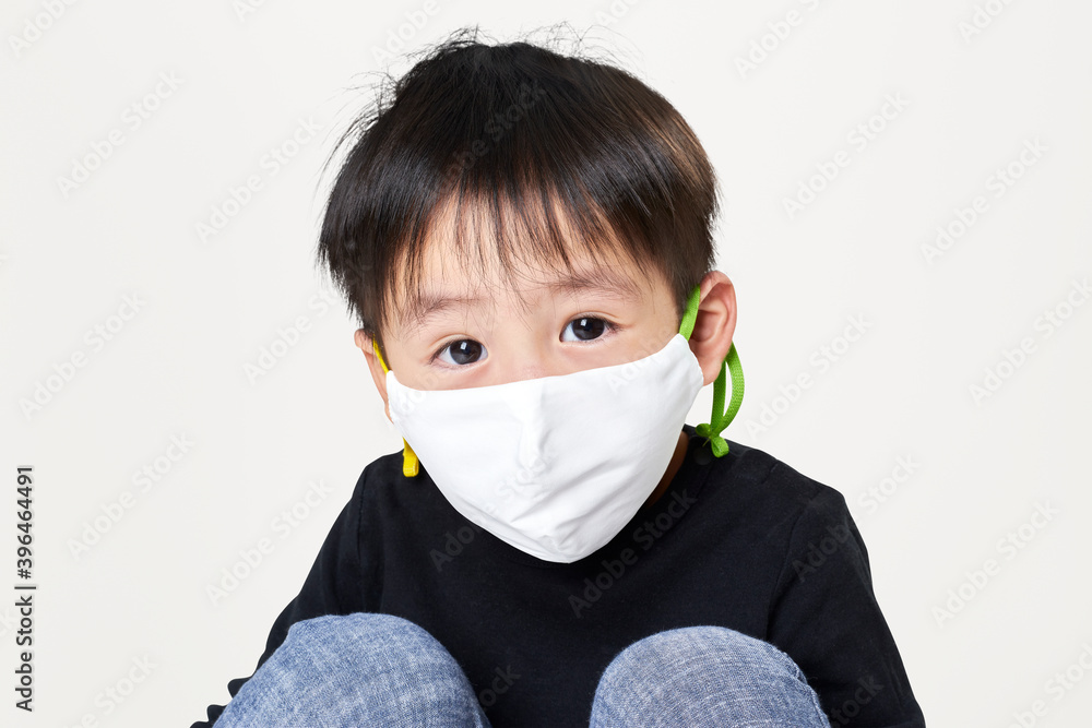 Boy wearing white face mask Stock Photo | Adobe Stock