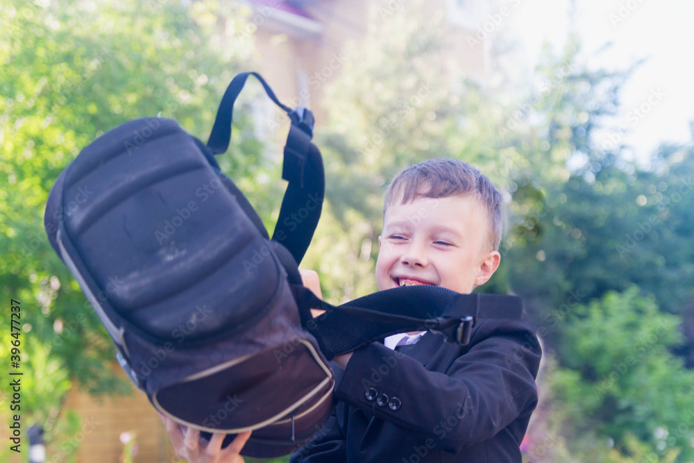 A teenage boy is a European schoolboy in a black suit, white shirt. The ...