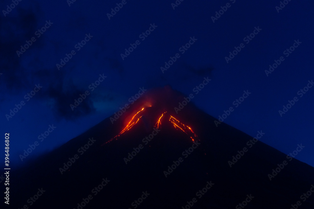 Beautiful night view of active volcano eruption, glowing red lava flows ...