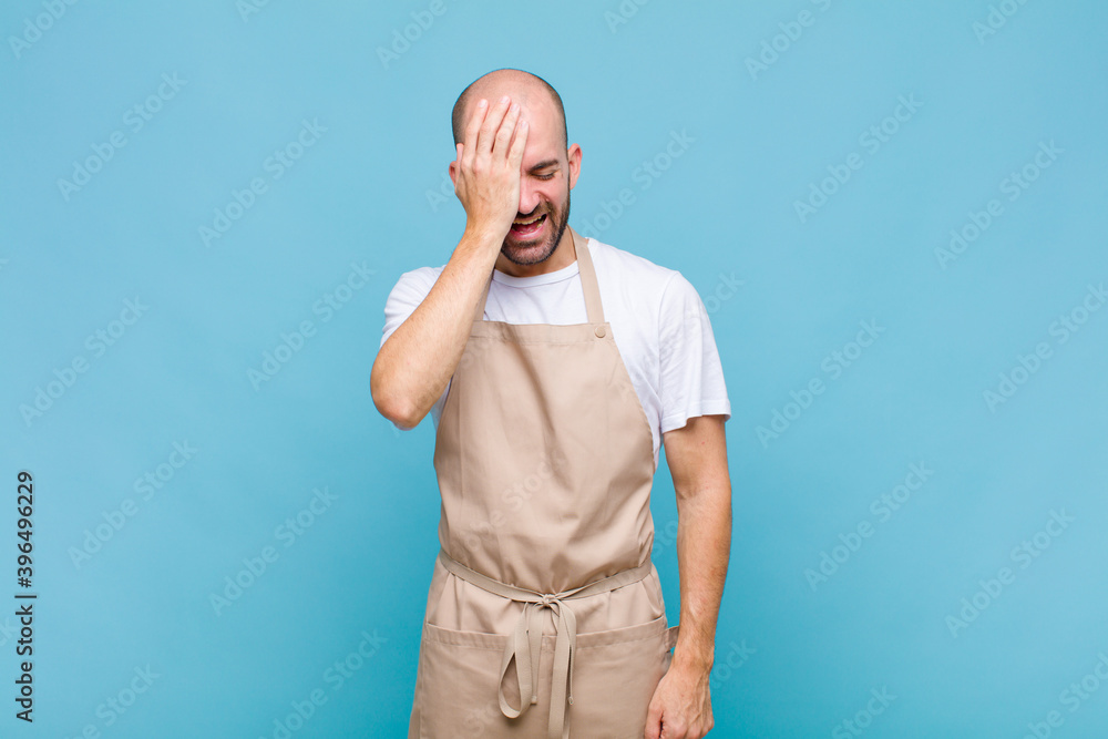 bald man laughing and slapping forehead like saying d’oh! I forgot or ...