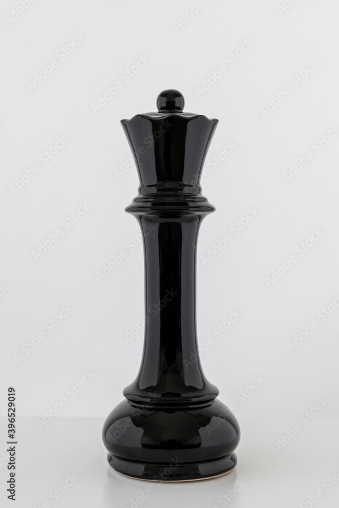 Black queen chess piece on off white background Stock Photo | Adobe Stock