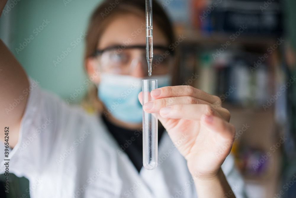 Test tube close up. Young woman scientist and medical doctor holding a ...