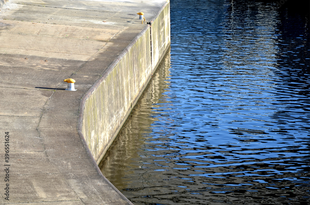 dock at the lock for the addition of river cargo ships. metal bollards ...