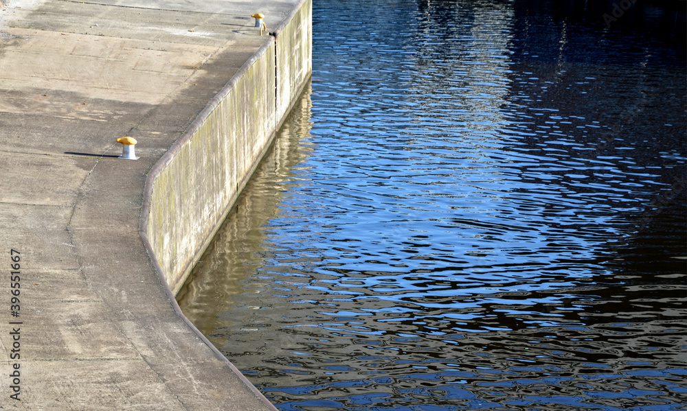 dock at the lock for the addition of river cargo ships. metal bollards ...