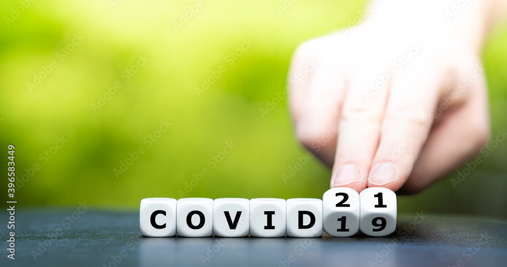 Symbol that the world has to deal with covid 19 in the year 2021. Hand ...