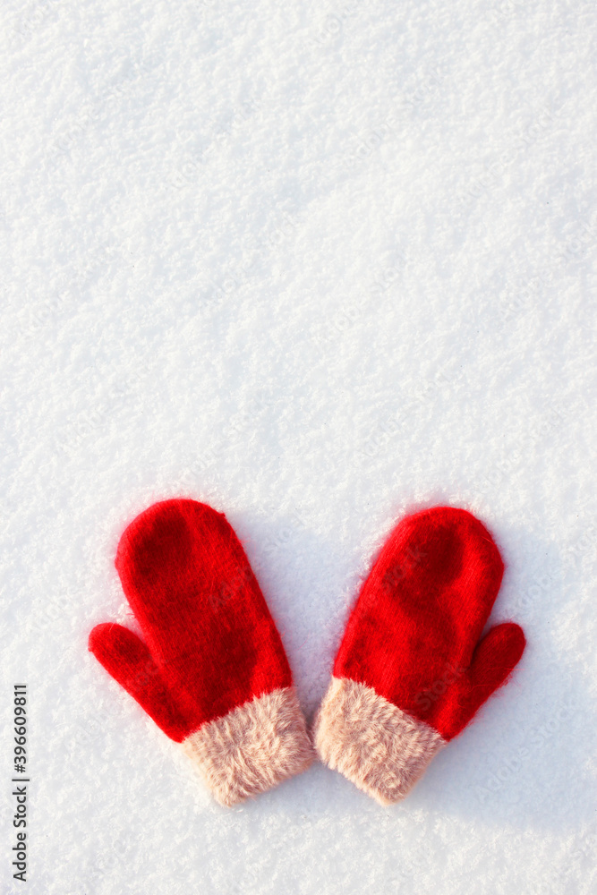 Red mittens lie on the snow. mitten lying on the snow in winter ...