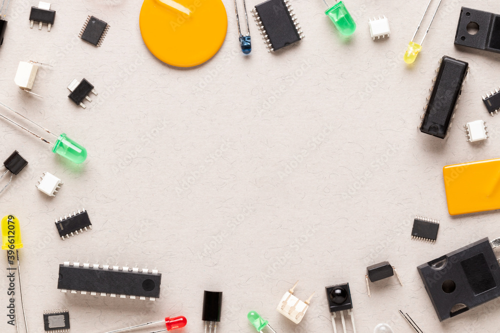 Electronic components on a beige background with copy space centered ...
