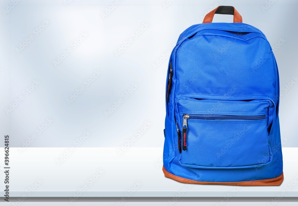 Blue school bag with school supplies on desk Stock Photo | Adobe Stock