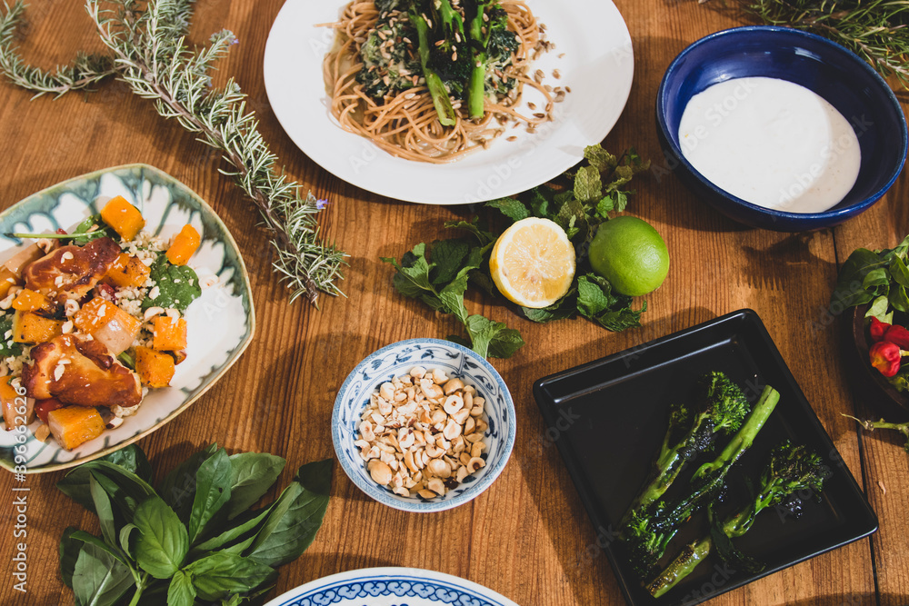 Grilled vegetables and healthy food dishes on a fancy wooden table ...