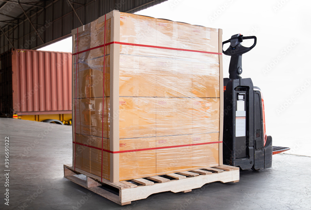 Packaging boxes stacked on pallet rack with forklift pallet jack ...