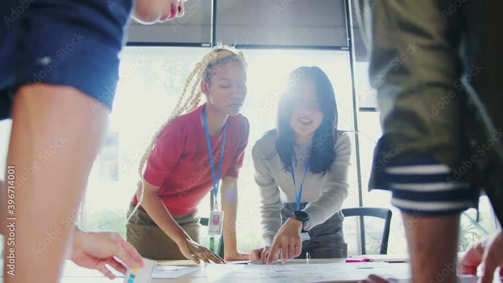 Group of creative designer and programing standing around table ...