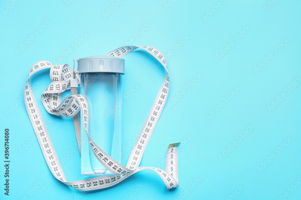 Bottle of water and measuring tape on color background Stock Photo ...