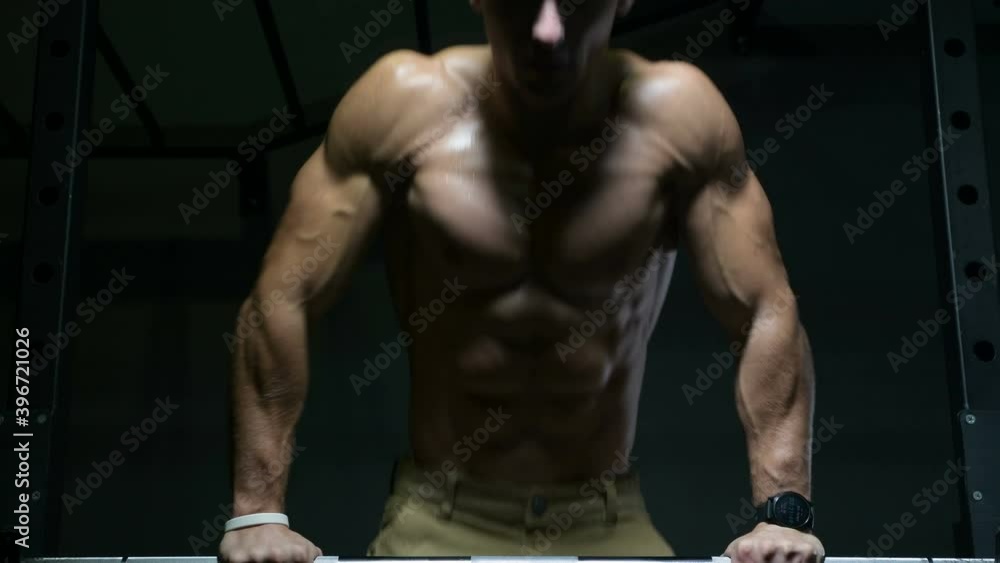 Fitness man doing push ups in gym. Strong bodybuilder with six pack ...