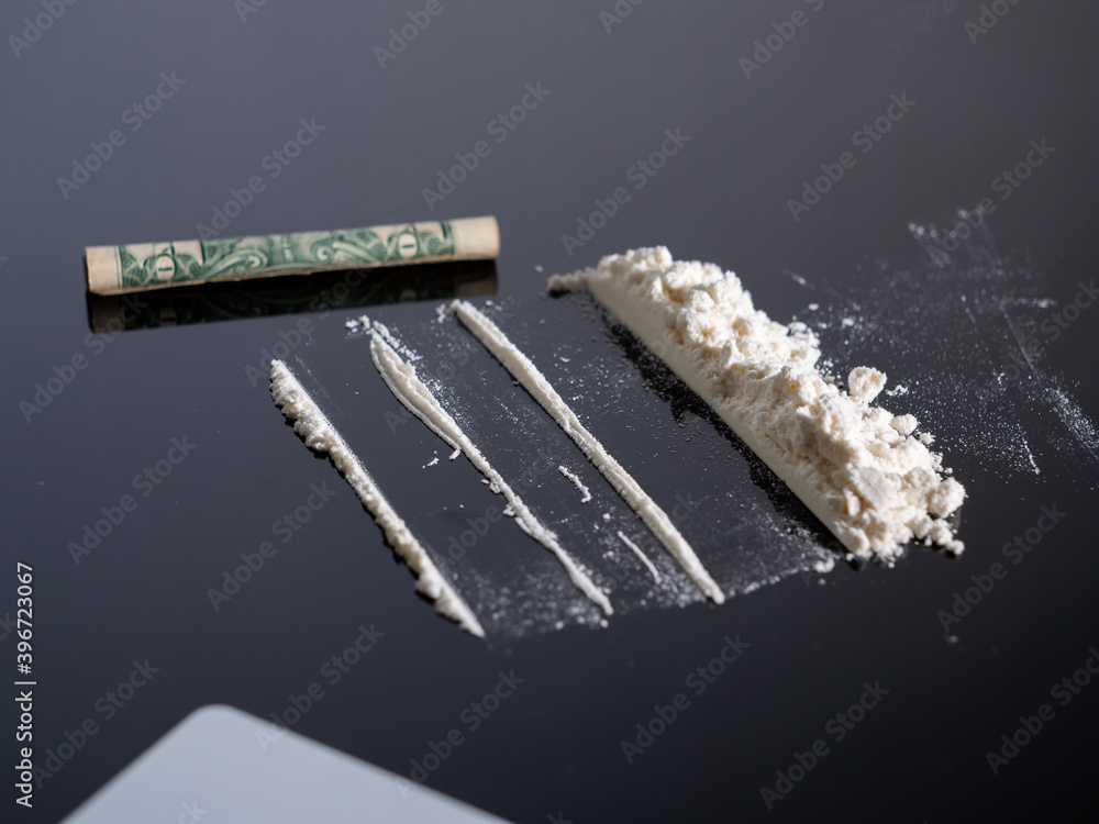Lines of cocaine and a dollar bill. Cocaine lines shots on a black ...