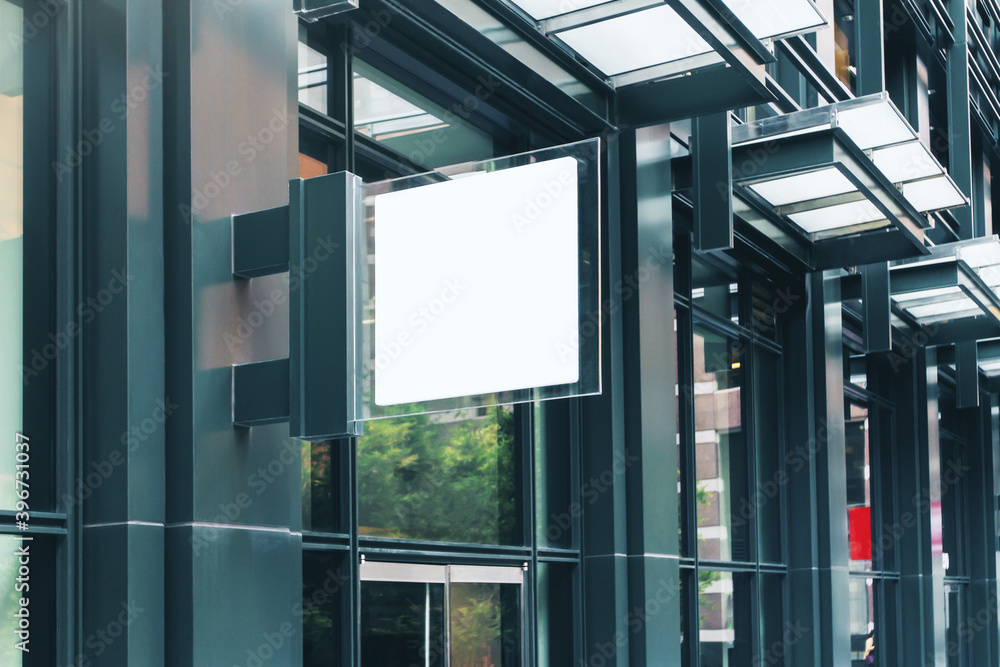 White square signboard on the wall of a modern shopping mall, mock up ...