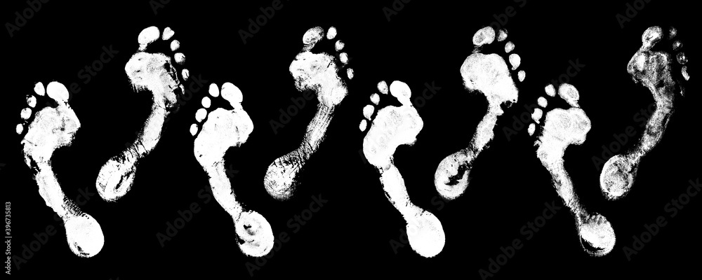 White human footprints set on black background isolated closeup ...