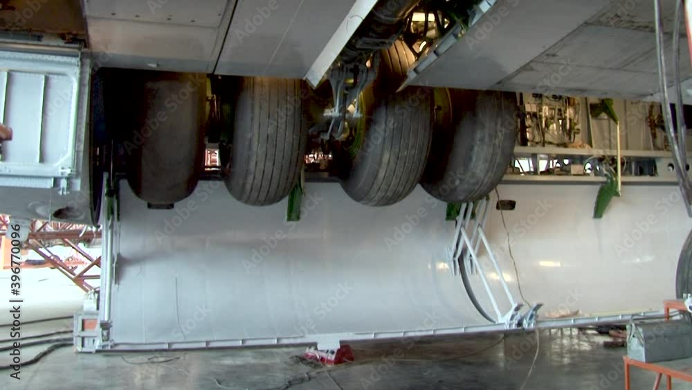 Chassis maintenance. Il-76 aircraft stands on hydraulic elevators ...