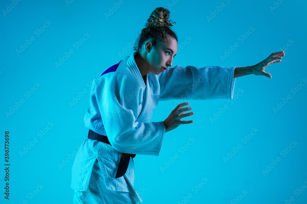 View from side. Professional female judoist in white judo kimono ...