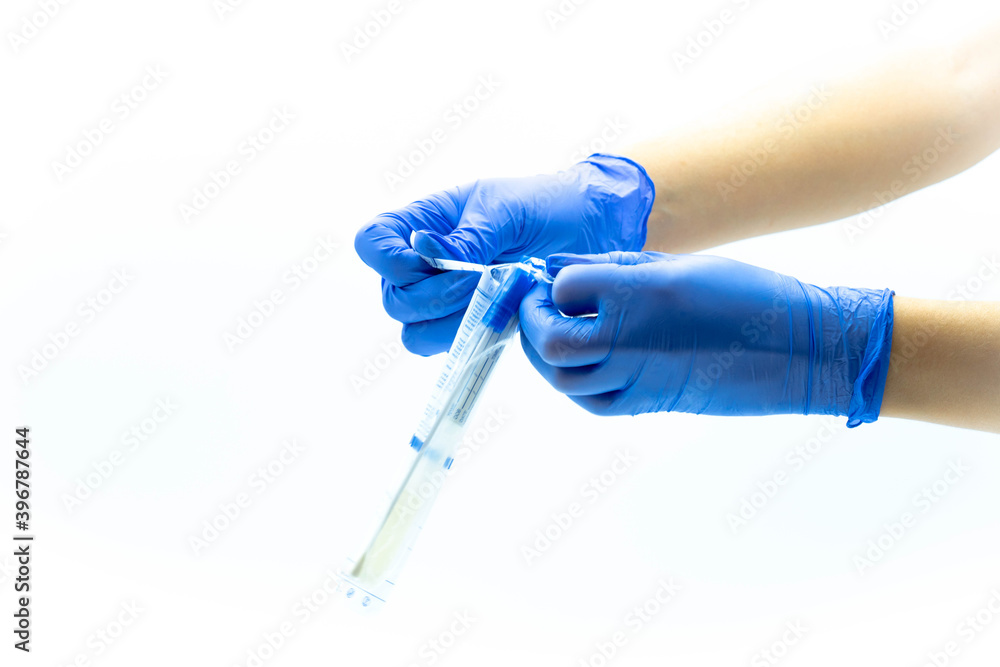 Hands of doctor with blue nitrile gloves opening a PCR test package ...