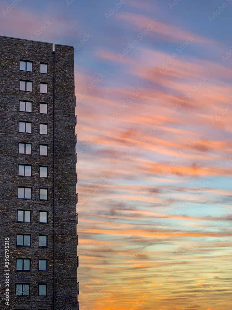 Tall brown brick skyscraper residential building with many windows ...