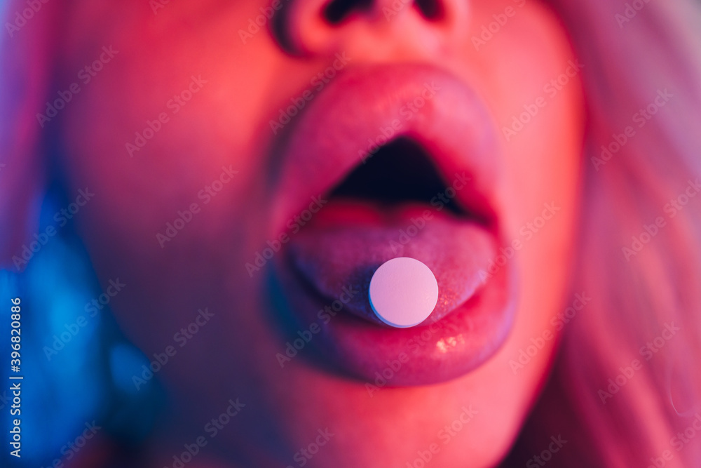 beautiful girl with lsd on tongue in nightclub with pink smoke. Stock ...