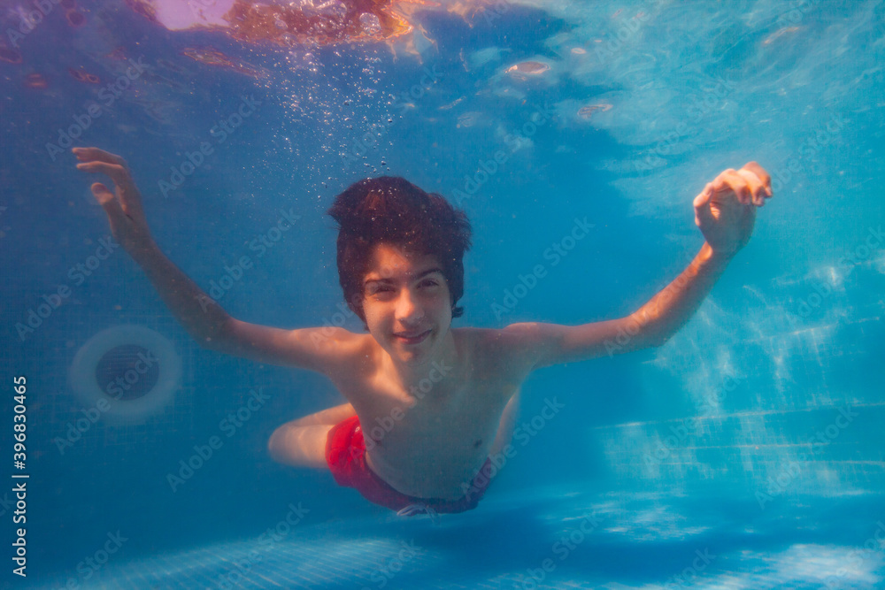 Happy handsome boy float underwater smiling portrait in the pool Stock ...