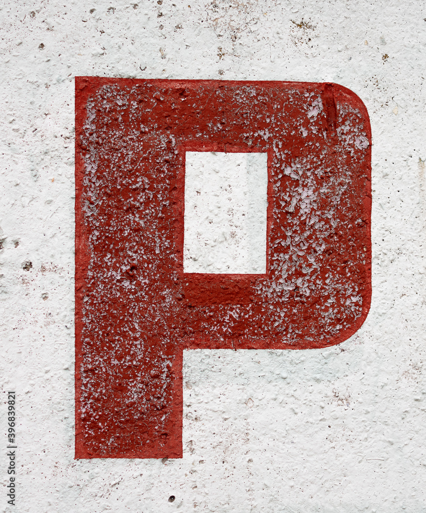The letter P is red on a worn white background. Grunge texture of old ...