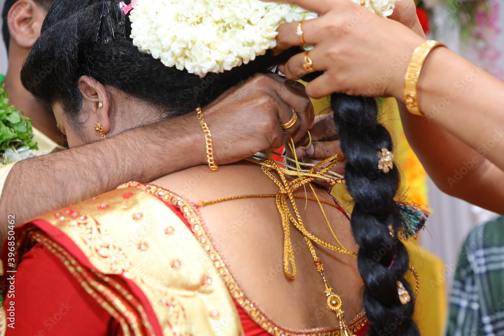 Groom tie a Thali/Tali knot to the Bride to take care of her for the ...