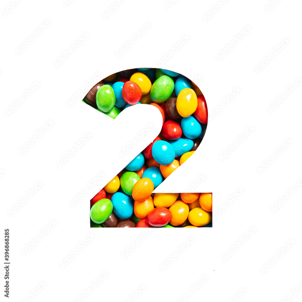 Number two of colourful candies and paper cut in shape of second ...