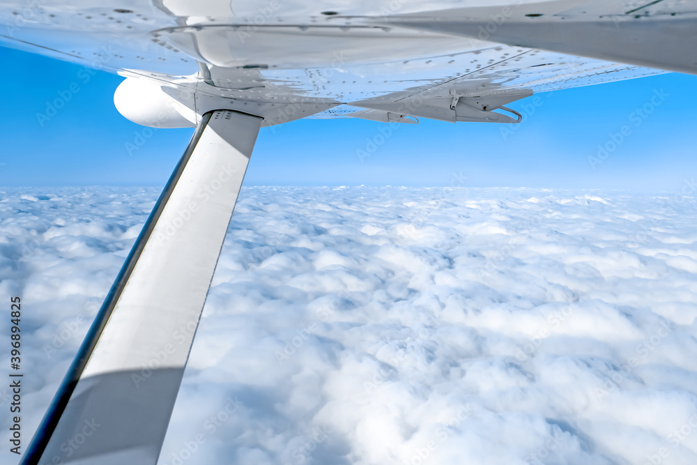Aeroplane wing. Fluffy clouds under the wing of the plane. Stock Photo ...