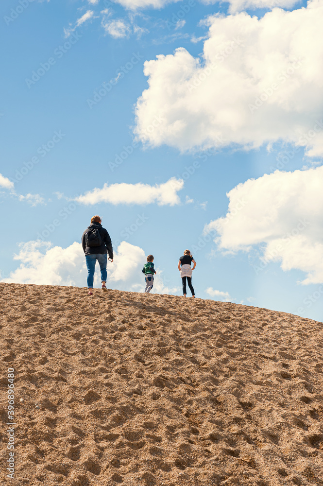 Family day out at the beach during sunny but windy day. Children ...