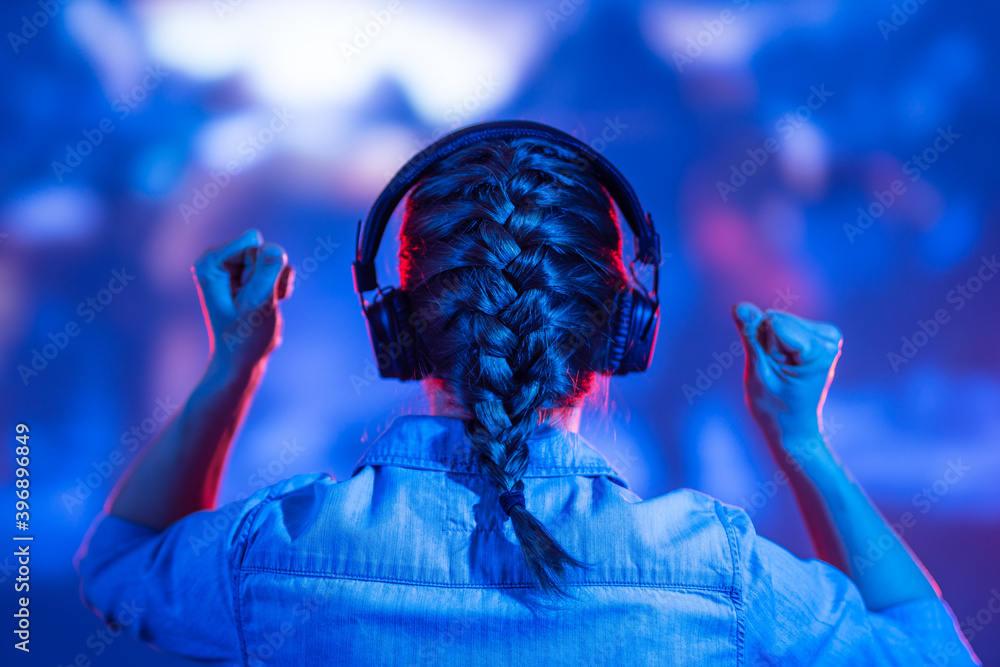 Close-up view from back of emotional gamer woman playing video game at ...