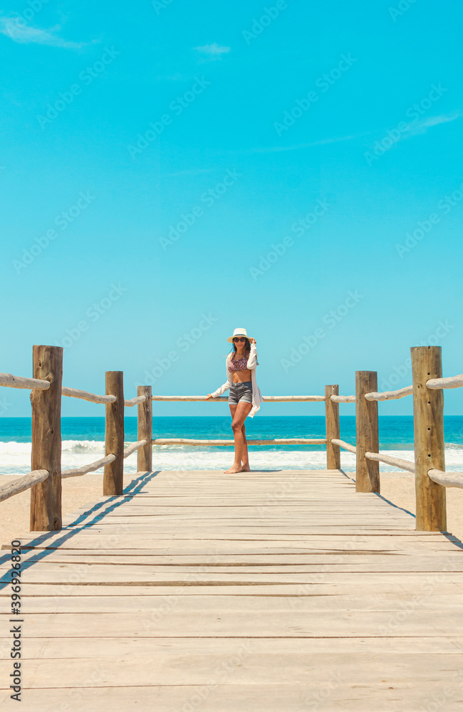 Beautiful woman Latin model enjoys the weather on the beach while ...