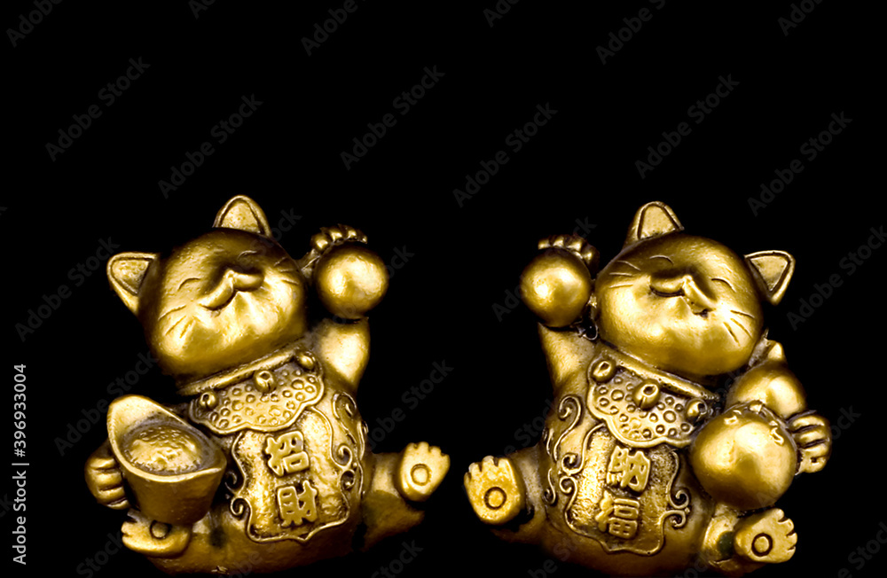 Gold Ceramic Maneki Neko Lucky Cats in black background. Beckoning Cats ...