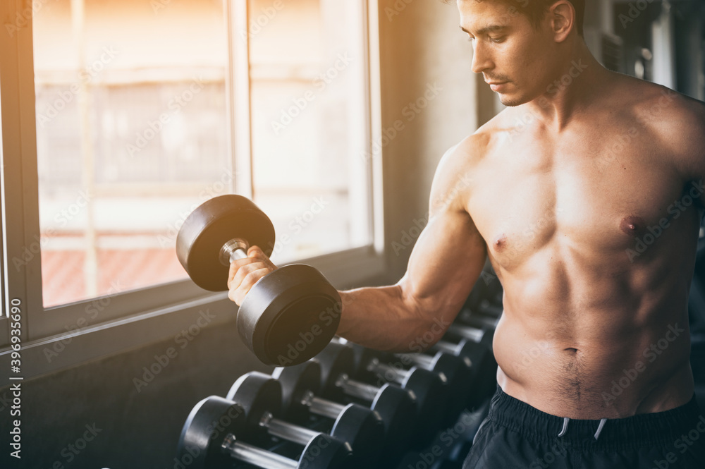 handsome and strong young man working out, Doing intense exercise in ...