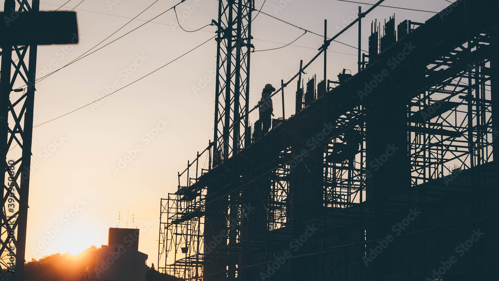 Silhouette Engineer and construction team working at site over blurred ...