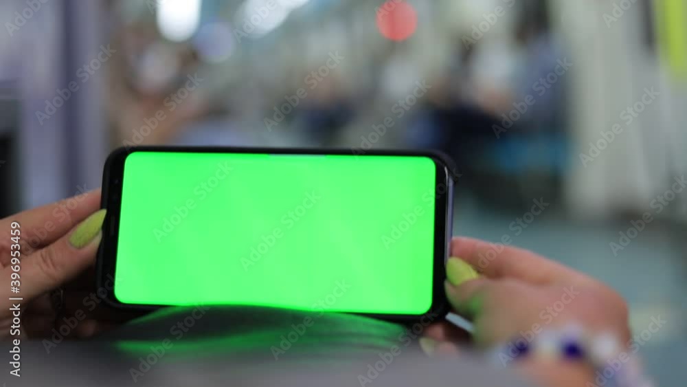 Female hands are holding a smartphone and touching the screen with ...