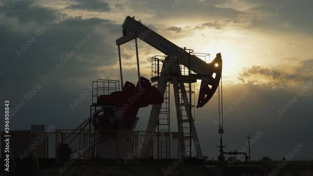 Oil mining, an oil rig in the field pumps out oil, view of an oil rig ...