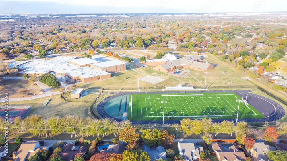 School football field with running track, soccer goal and residential ...