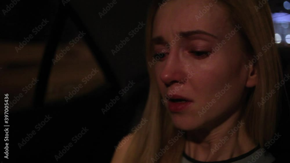 Close-up on the face of a young Caucasian girl whose tears are ...