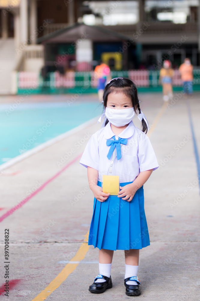 Student wearing school uniform and cloth mask to school. New normal ...