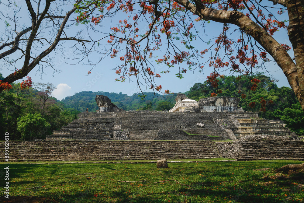 Maya temple ruins with palace and observation tower under orange ...
