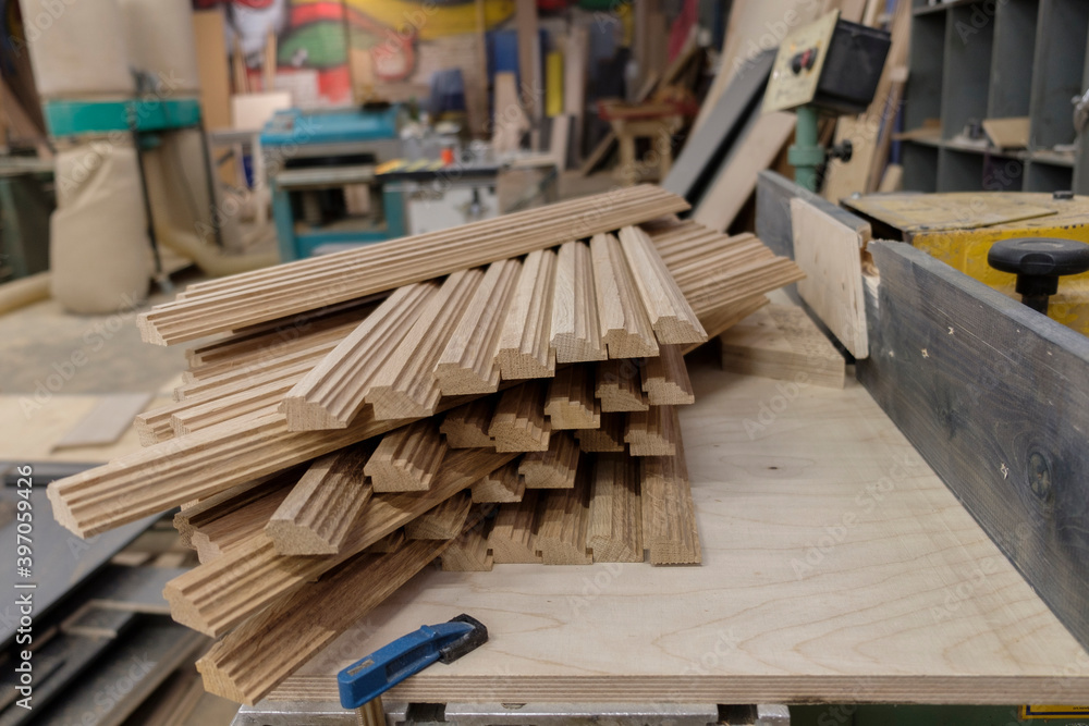 An oak wood bar blocks materials stacked in a wood joiner's workshop ...