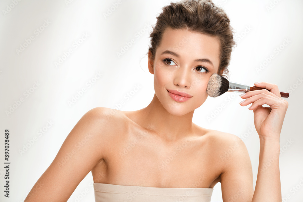 Woman applying powder on the face using makeup brush. Photo of woman ...