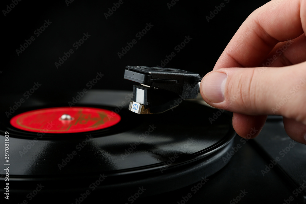 vinyl record on a turntable. turntable head close-up on black ...